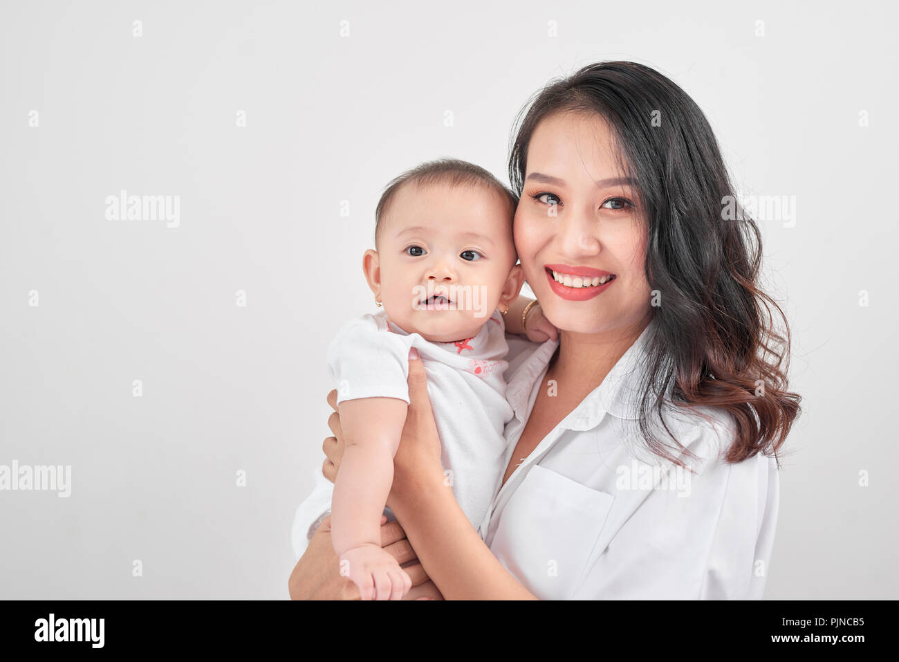 Happy loving family. Young smiling mother hugging laughing baby Stock ...