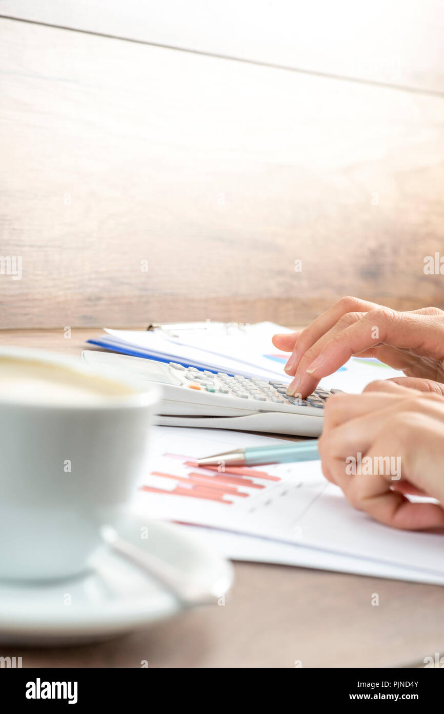 Closeup of female hands making mathematical and statistical ...