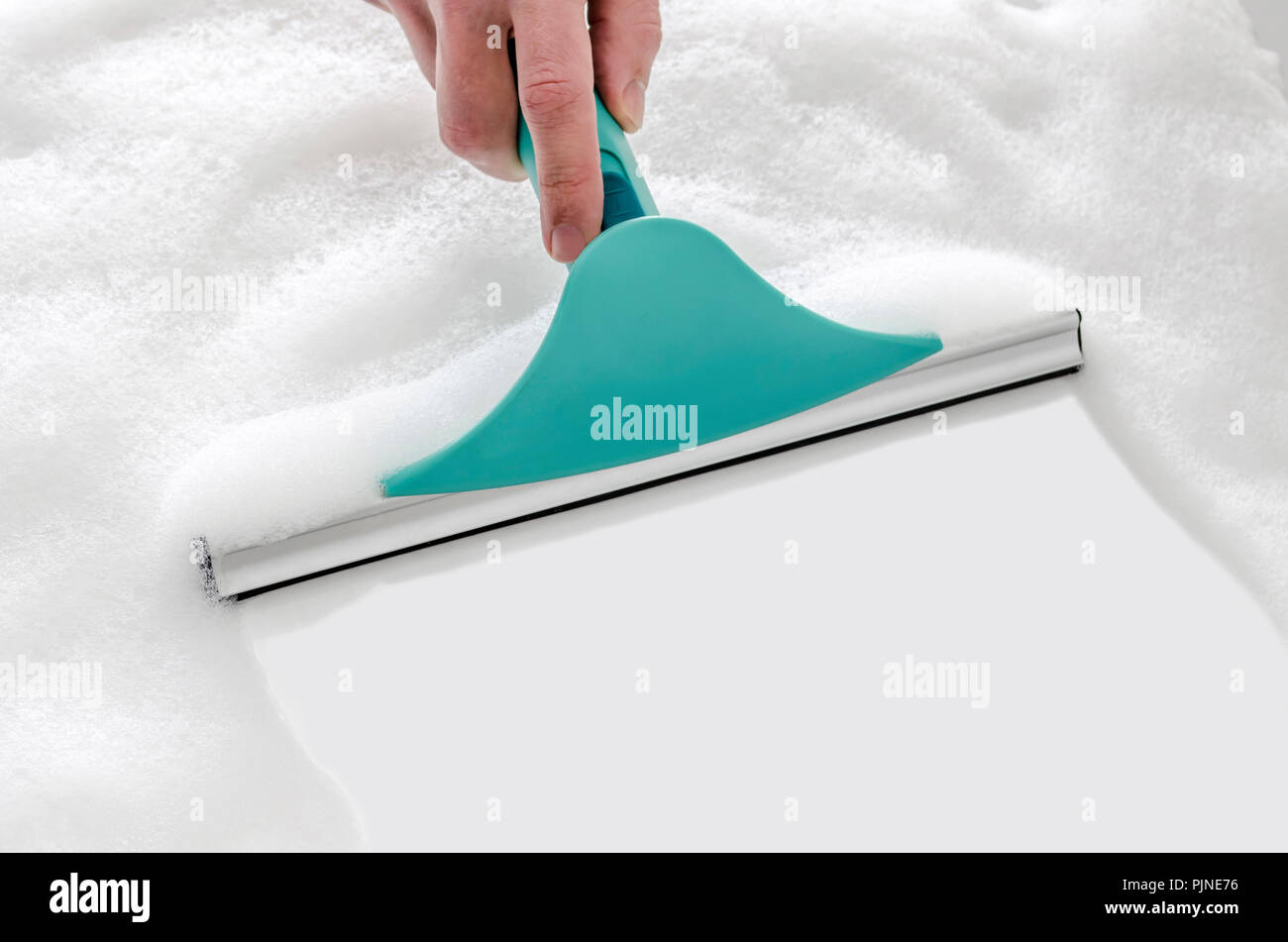 Hand cleaning white shiny surface with rubber window cleaner Stock ...