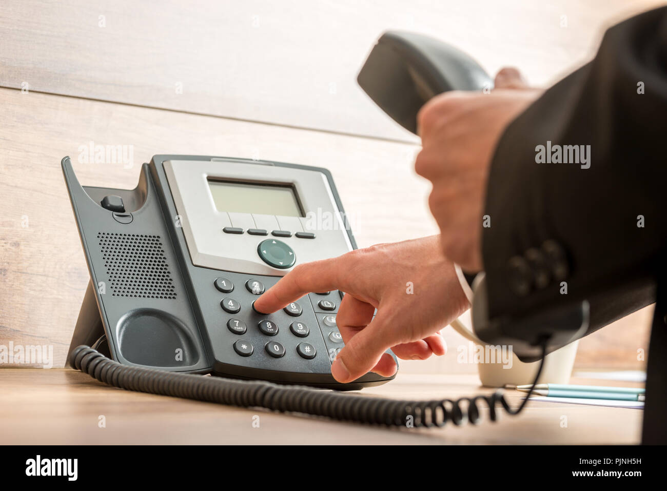 Hand holding landline phone hi-res stock photography and images - Alamy