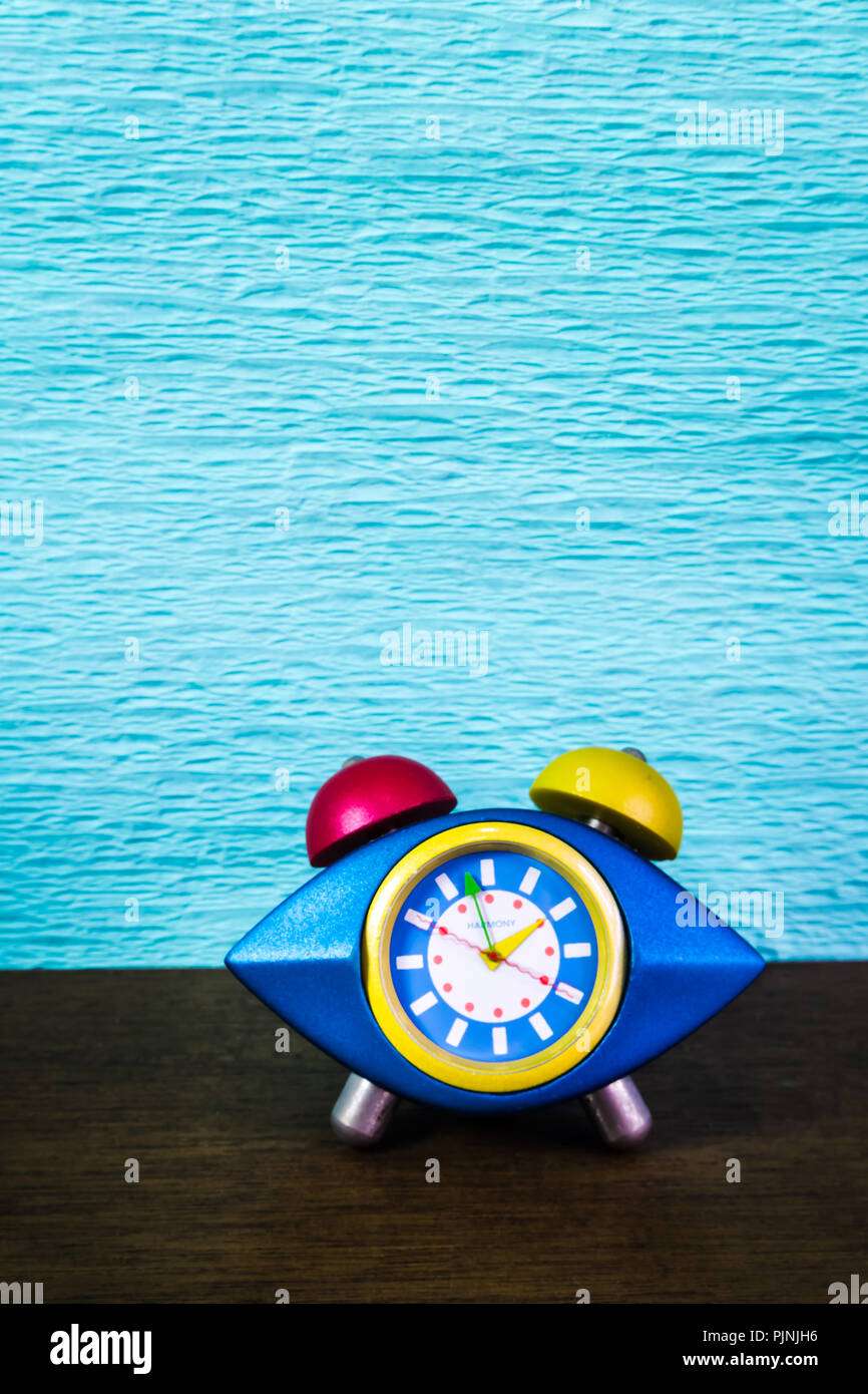 Colorful alarm clock isolated on a blue colored background Stock Photo ...