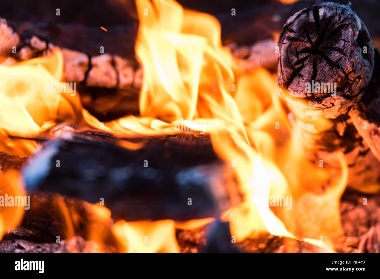 Wooden planks on fire close up background Stock Photo - Alamy