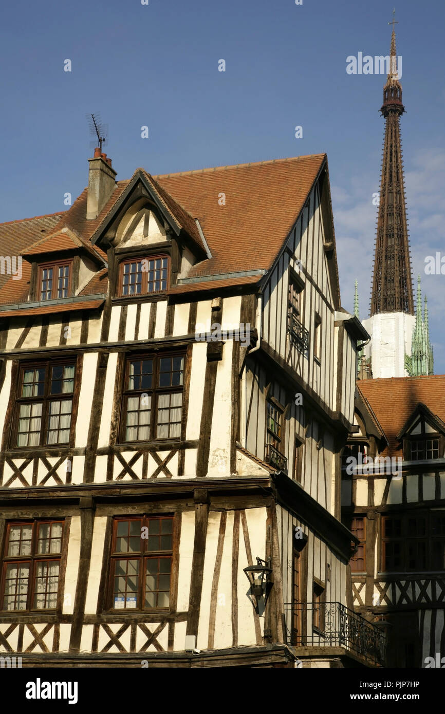 Half timbered building with the spire of the Cathedral of Notre Dame ...