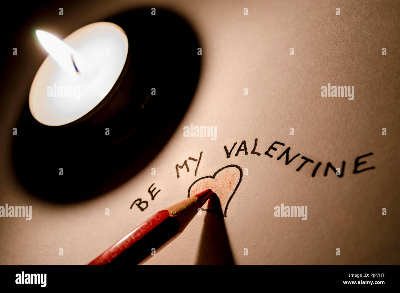 Pencil writing a Be my Valentine note- romantic scene with candle Stock ...