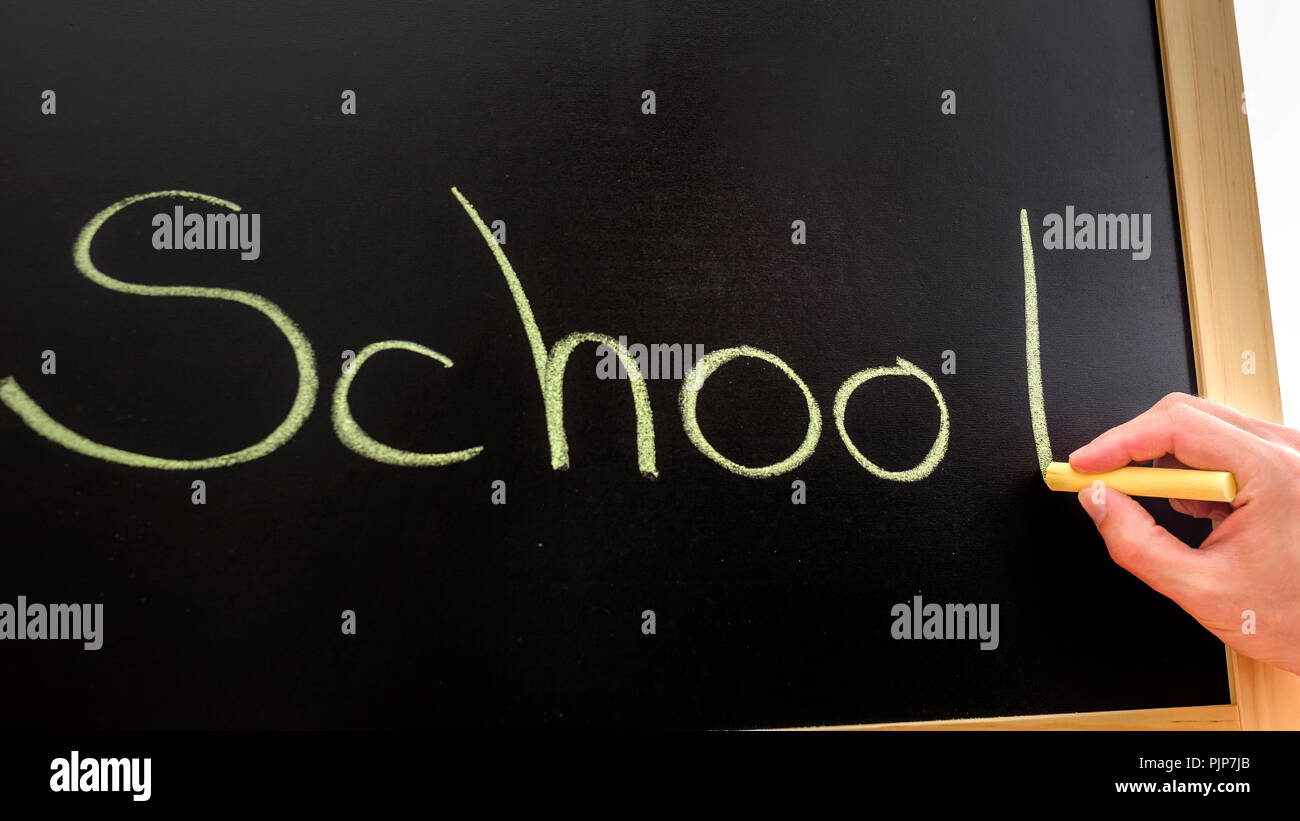 Writing word school with yellow chalk on blackboard Stock Photo - Alamy