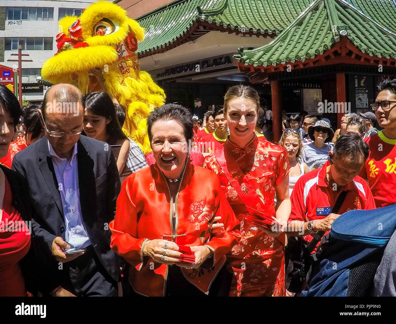 Sydney's Lord Mayor Clover Moore (C) pictured handing out lucky red ...