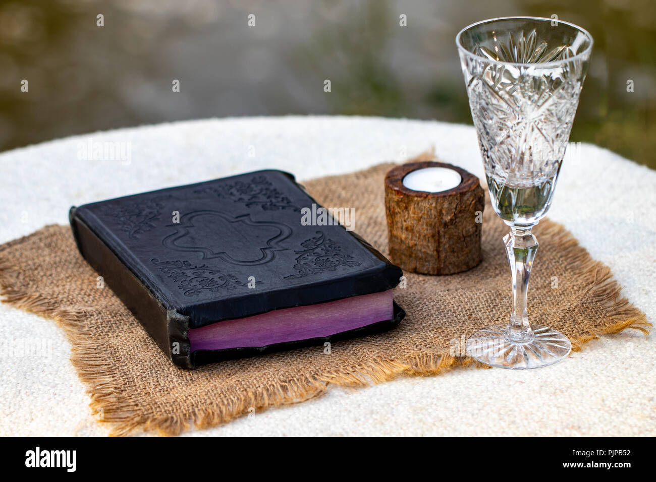 Taking Communion. Cup of glass with red wine, bread and Holy Bible on ...