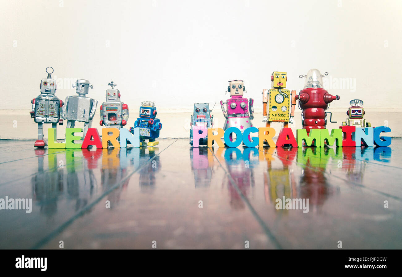LEARN PROGRAMMING wooden letters and retro robot toys on a wooden floor ...