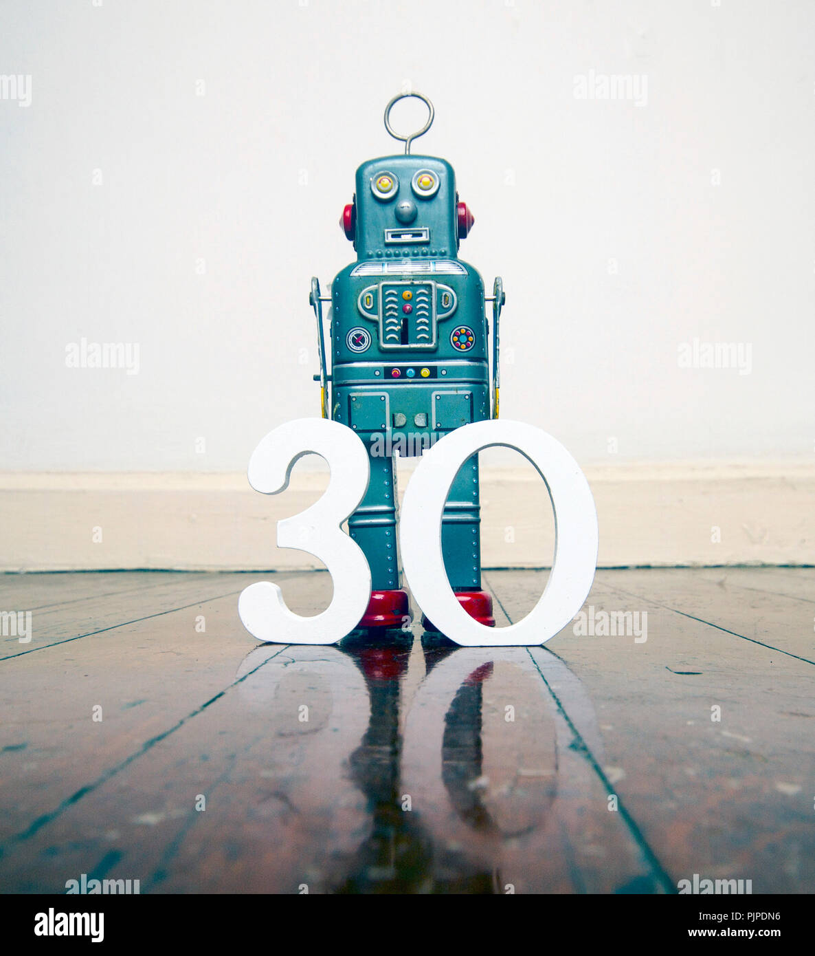 robot and the number 30 on a old wooden floor with reflection Stock ...