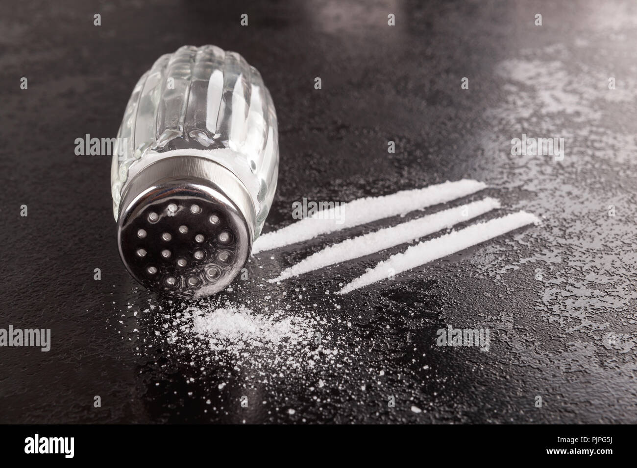 Classic crystal salt in salt shaker. Addiction concept Stock Photo - Alamy