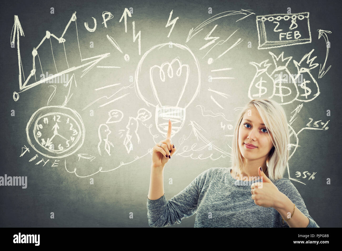 Enthusiastic young woman showing thumb up gesture with one hand and ...
