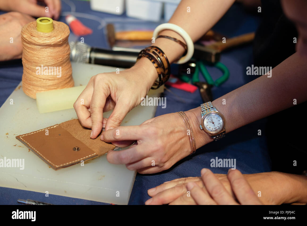 craftsman making leather bag. handmade DIY handicraft workshop Stock ...