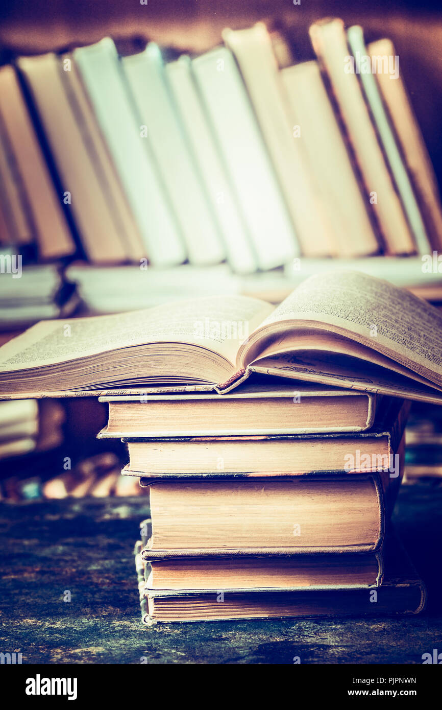 Stack of old books at rack with books, front view. Reading,schooling or ...