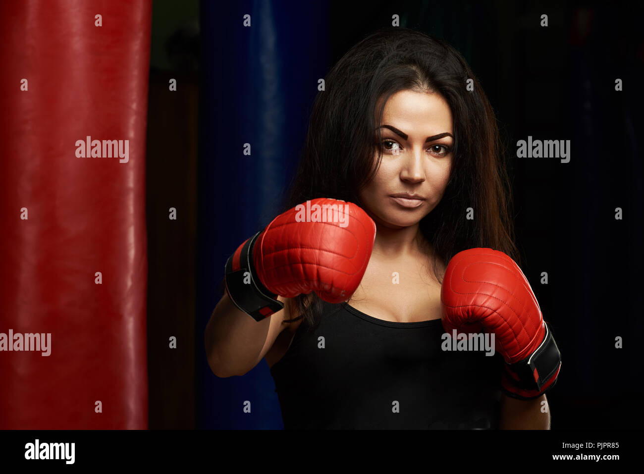 Portrait of exercising boxing woman on gym background Stock Photo - Alamy