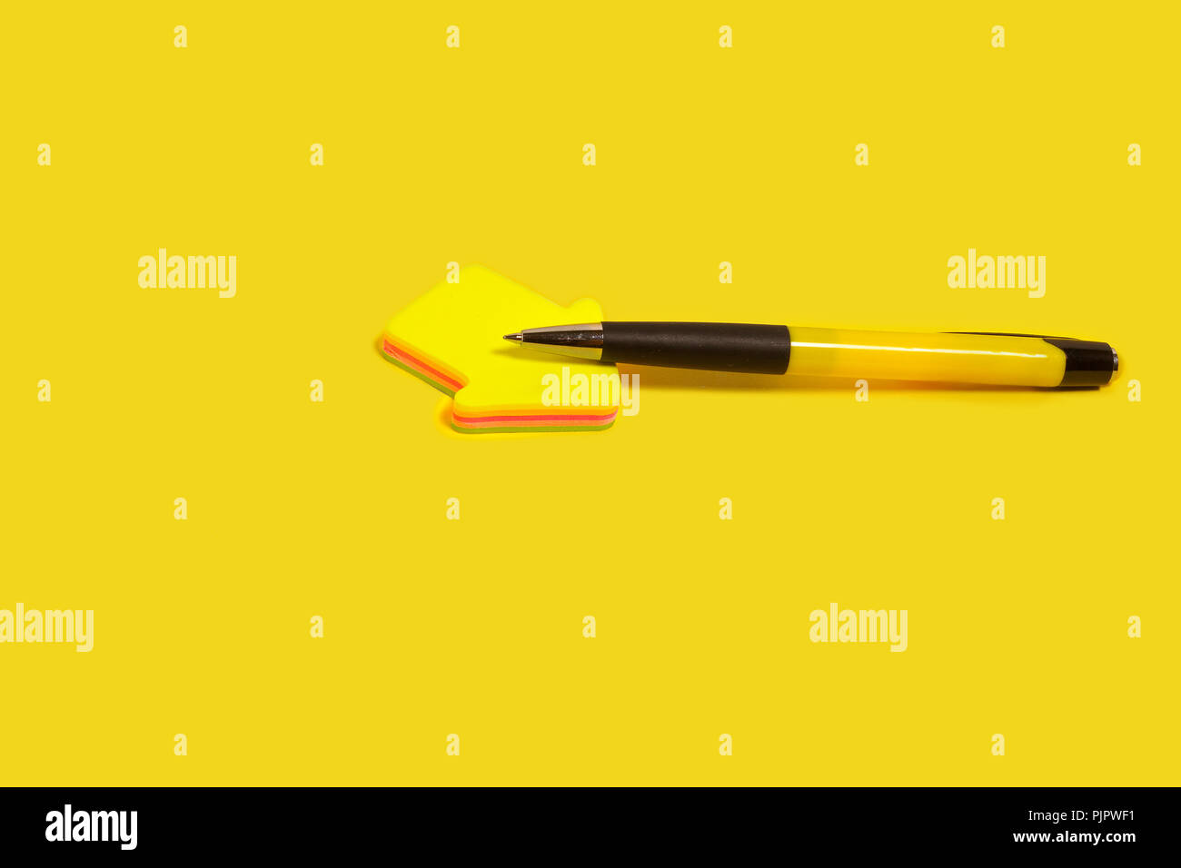 new bright plastic automatic yellow and black pen lying on a sticky ...