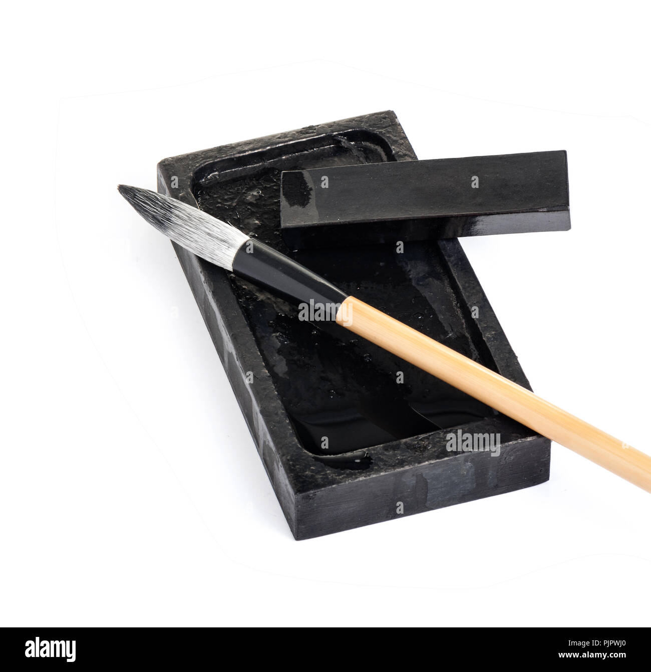 inkstone, inkstick and traditional writing brush isolated on white ...