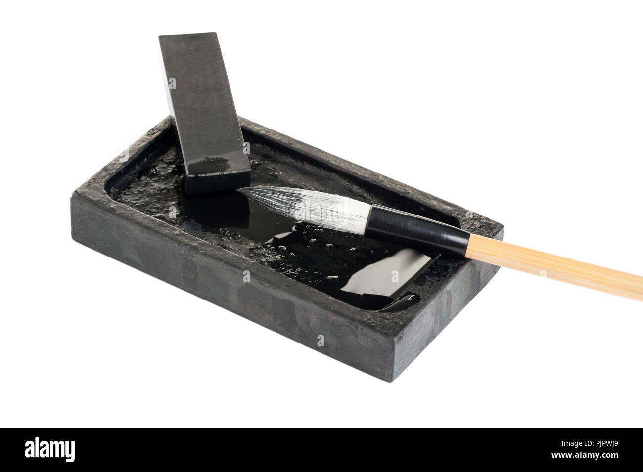 inkstone, inkstick and traditional writing brush isolated on white ...