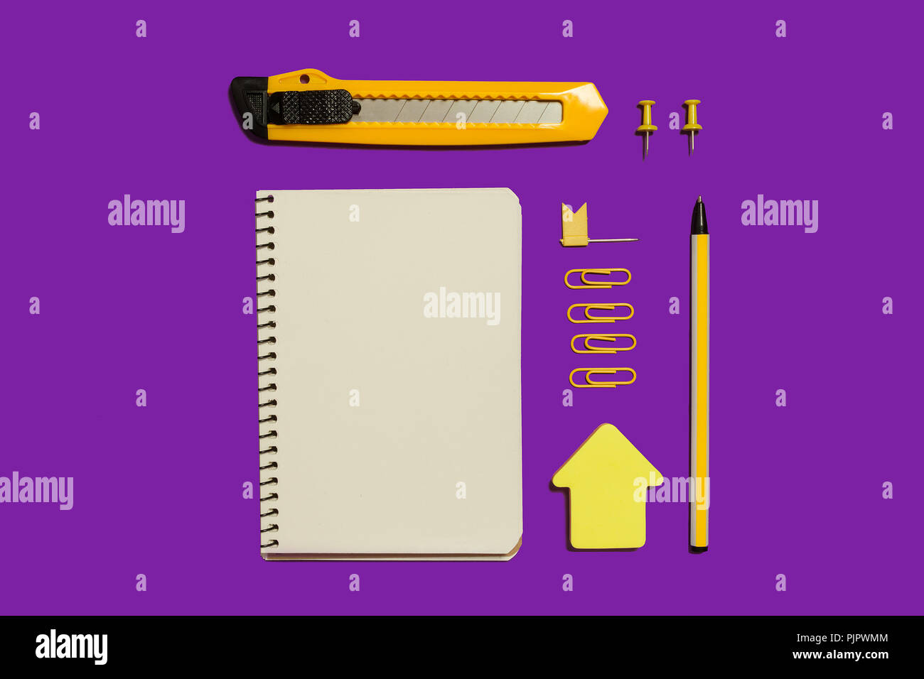 opened notebook, colorful stickers, paper clips, pen and stationary ...