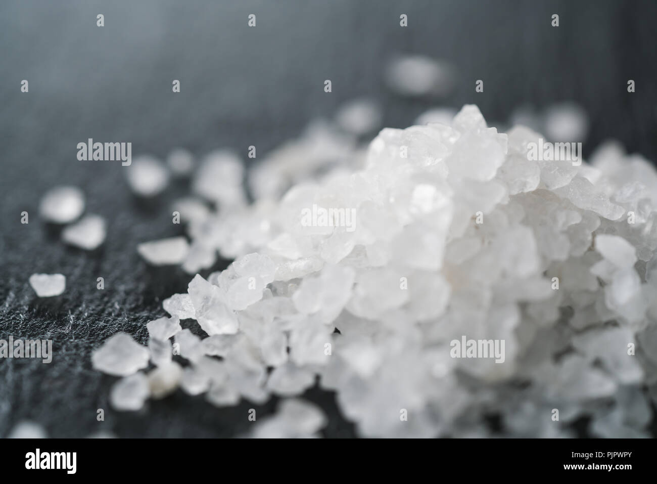 Close-up sea salt on slate background, shallow focus Stock Photo - Alamy