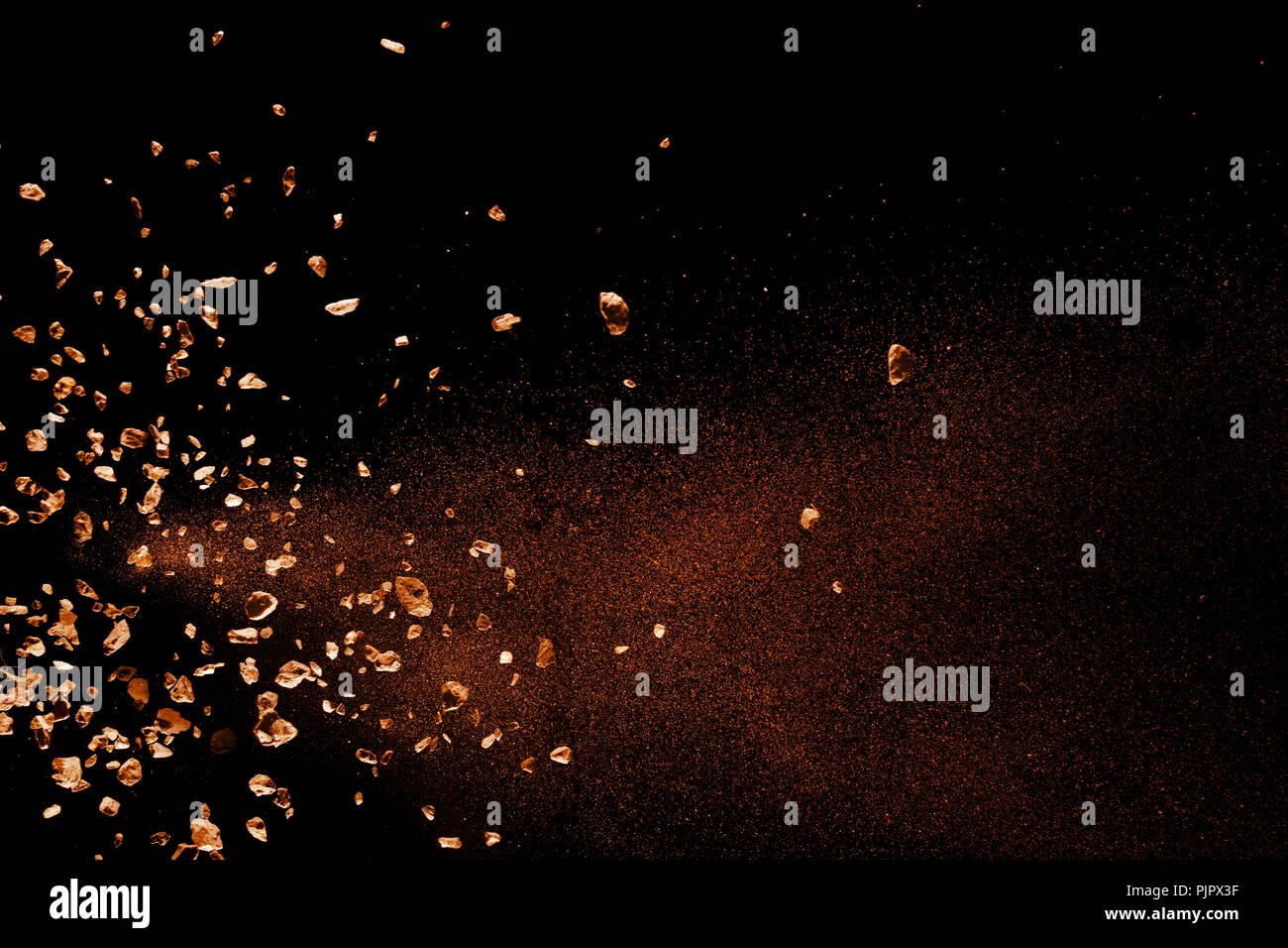 Split debris of stone exploding against black background Stock Photo ...