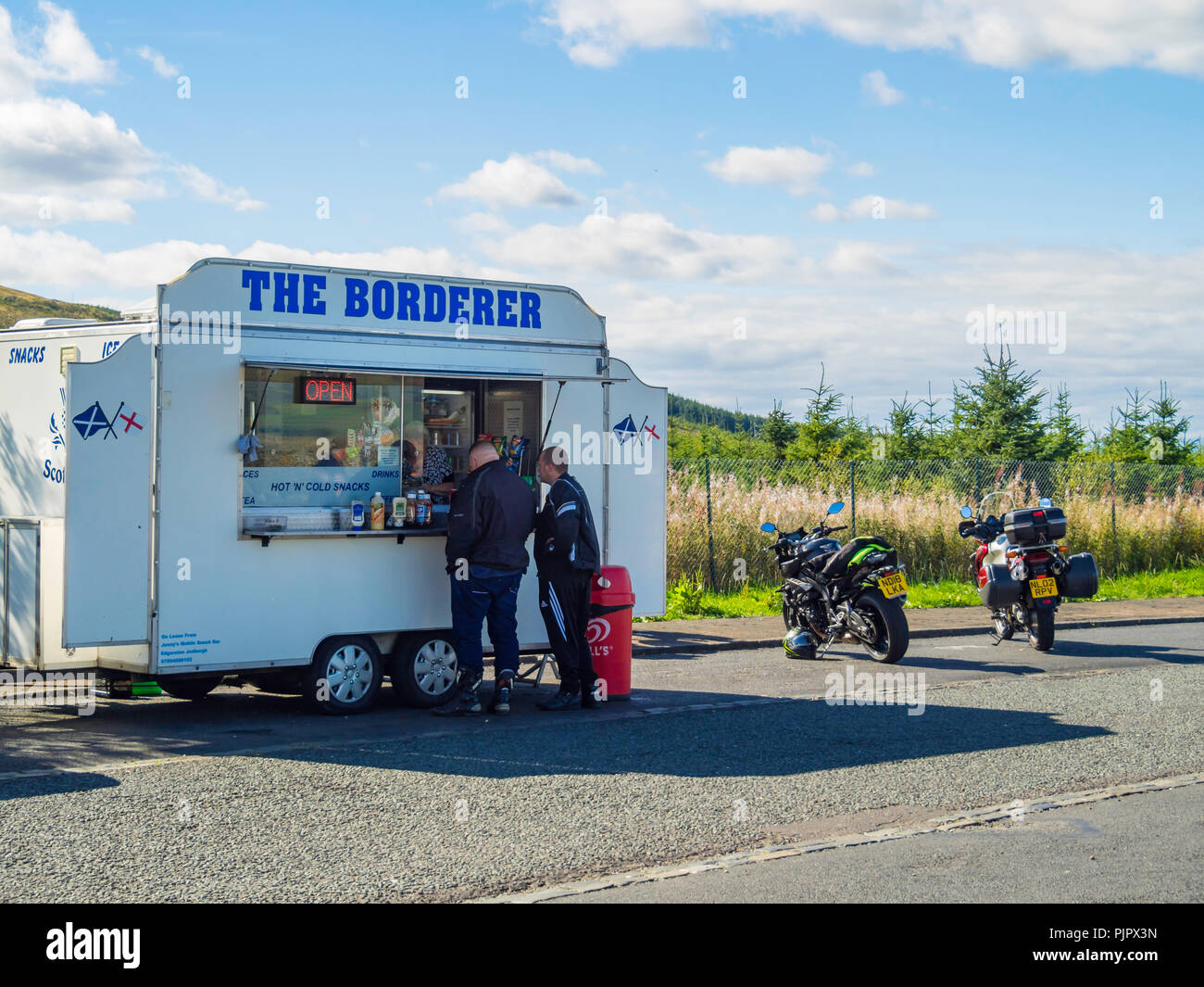 Two Motorcyclists stop for refresment at The Bordere Café van at Carter ...