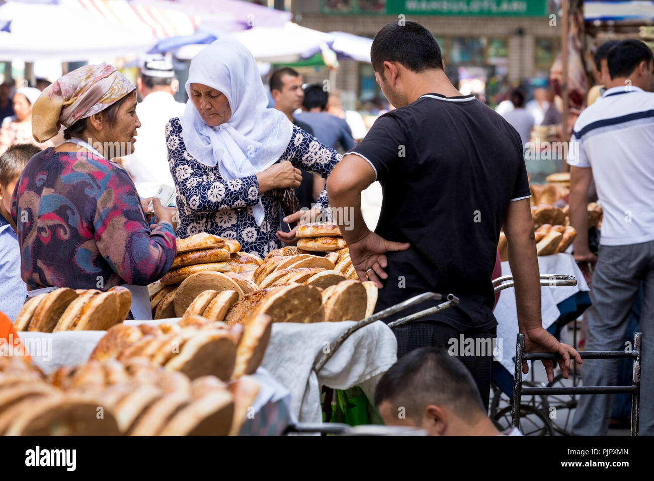 MARGILAN, UZBEKISTAN - AUGUST 24, 2018: National plain uzbek bread sold ...