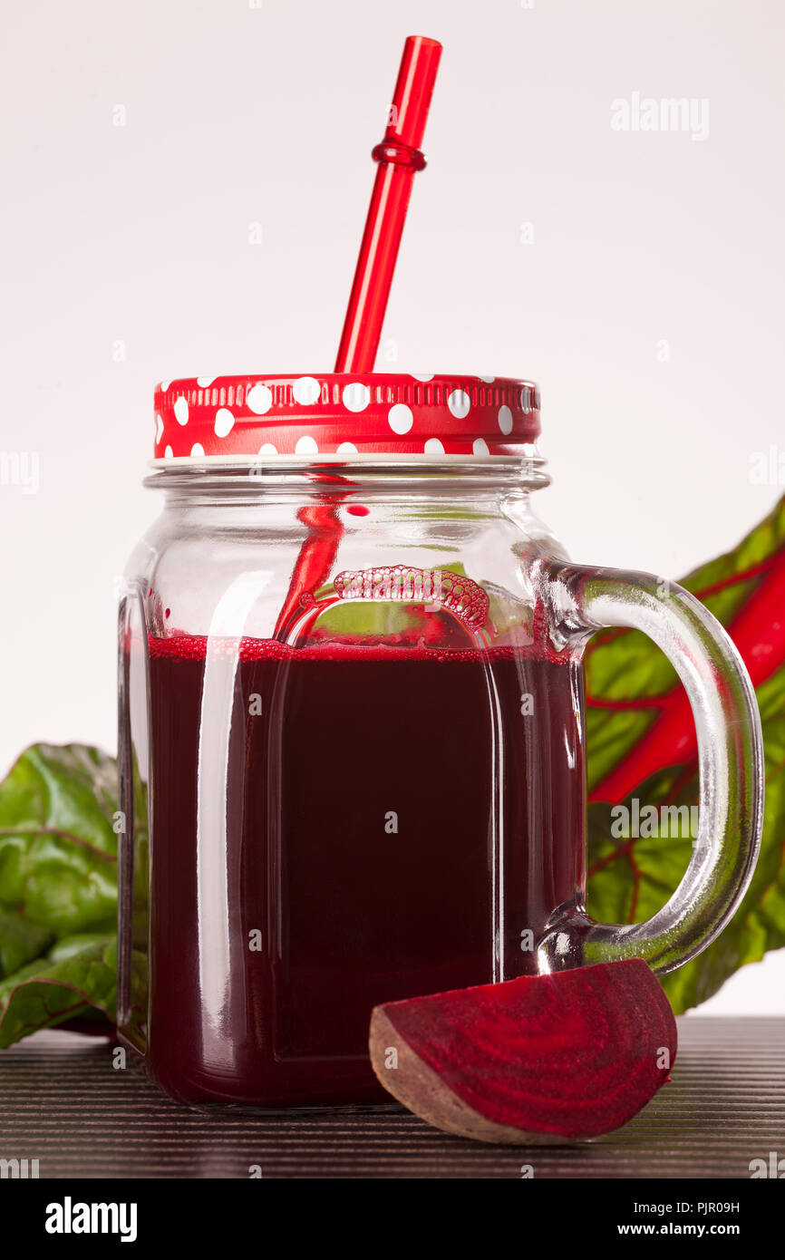 glass jar of beetroot juice on white background Stock Photo - Alamy