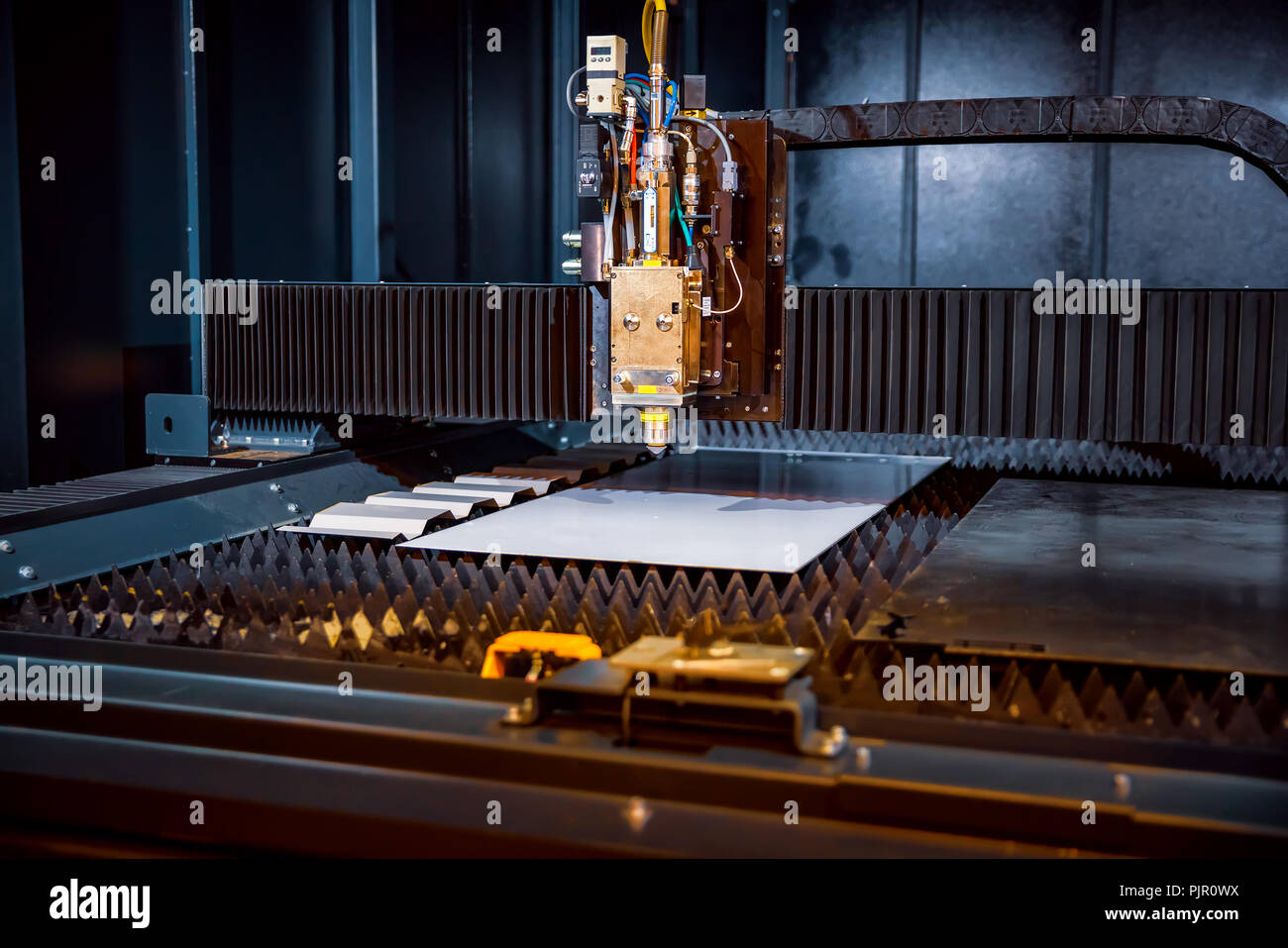 CNC Laser cutting of metal, modern industrial technology. Small depth ...