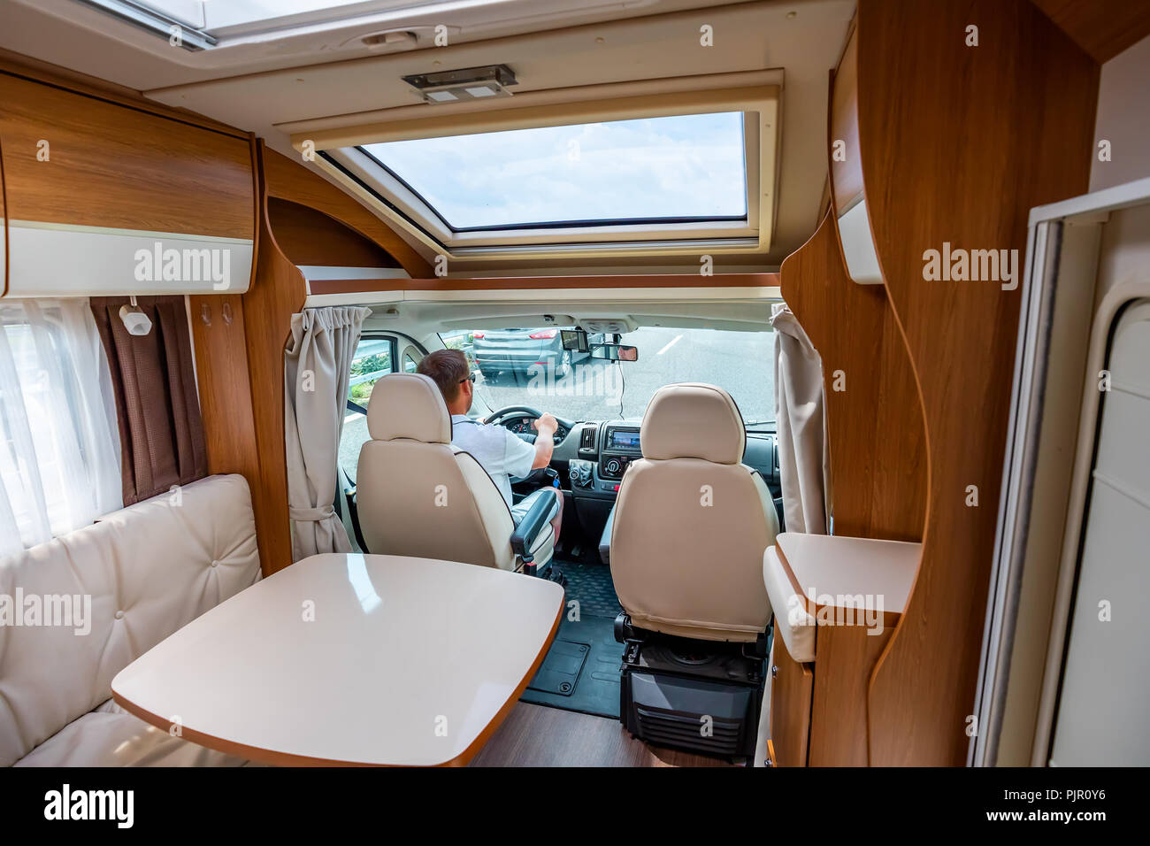 Man driving on a road in the Camper Van RV. Caravan car Vacation ...