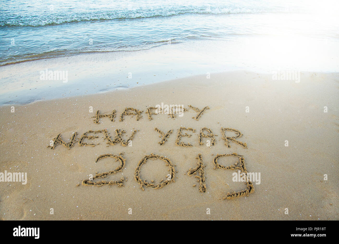 Happy new year written on the sand Stock Photo - Alamy