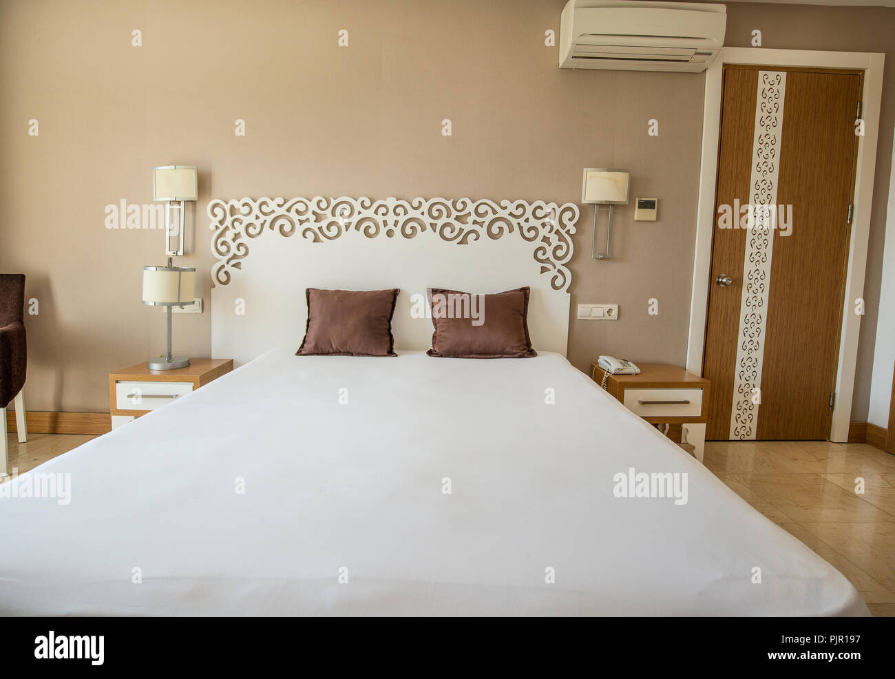 Air conditioned hotel room with single double bed Stock Photo - Alamy