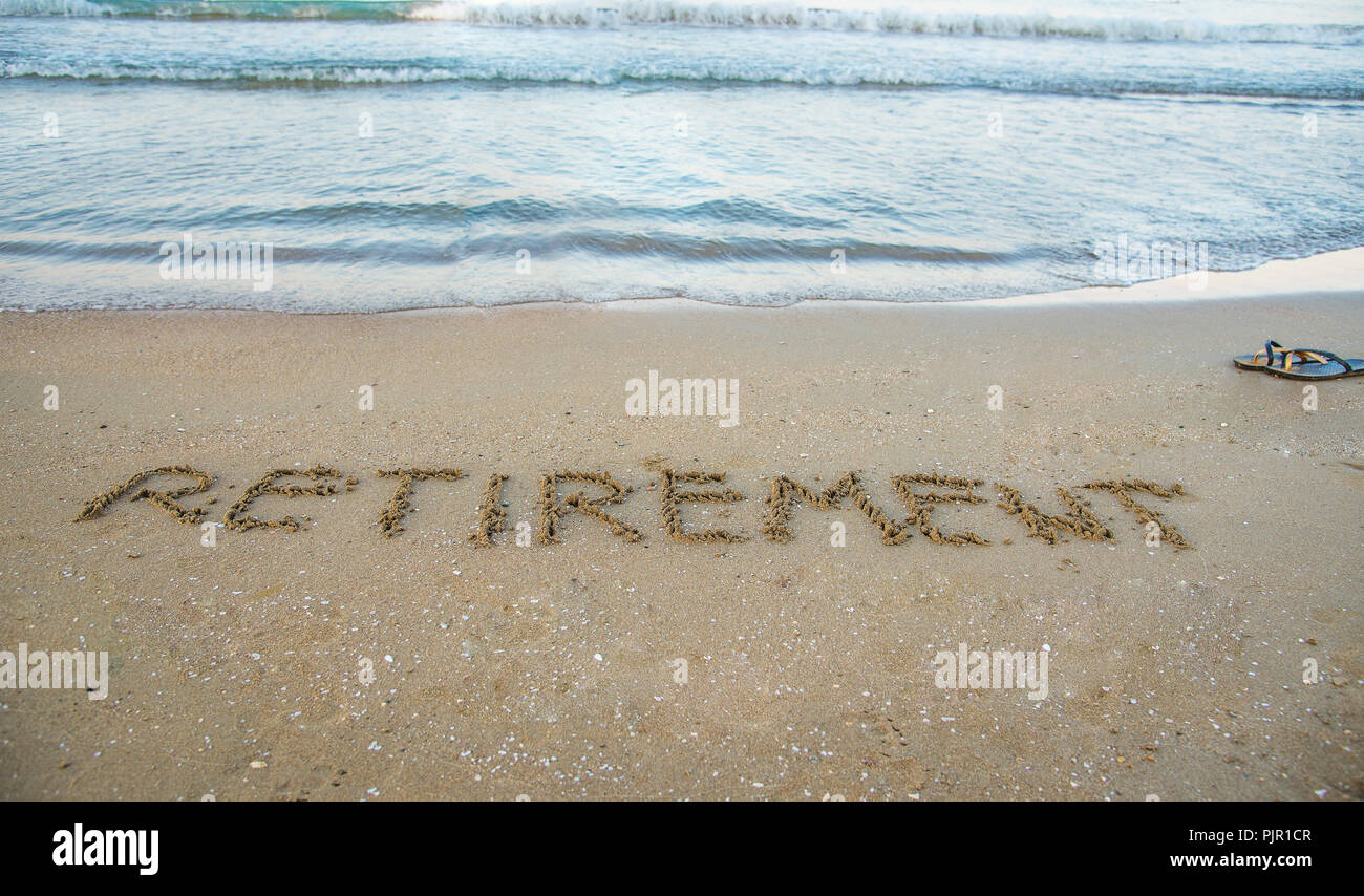 Retirement written on sand by sea at beach Stock Photo - Alamy