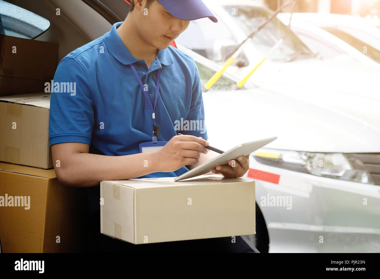 Delivery man working with box on tail truck car Stock Photo - Alamy