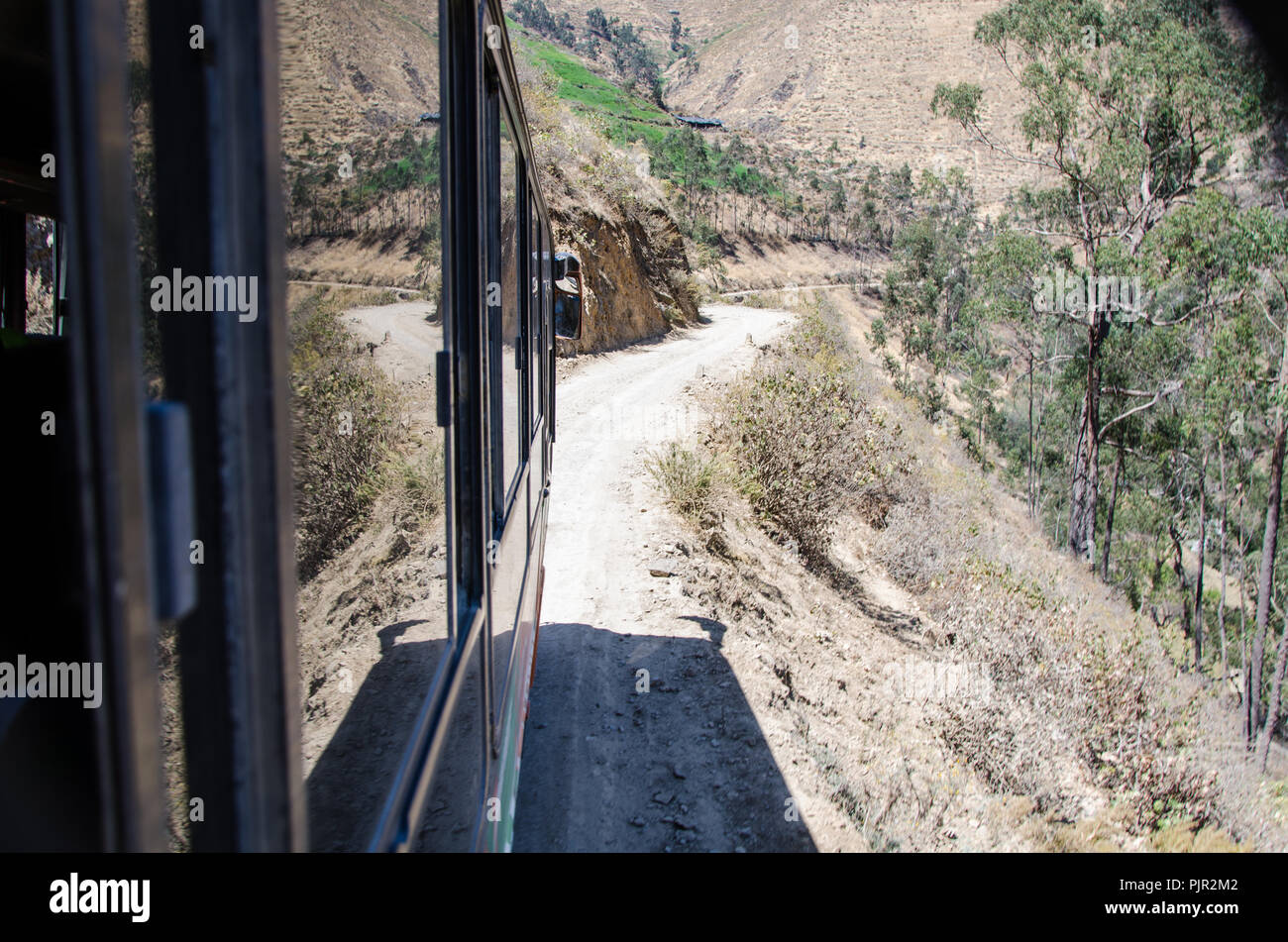 View through the window of a mountain road with forest on both sides on ...