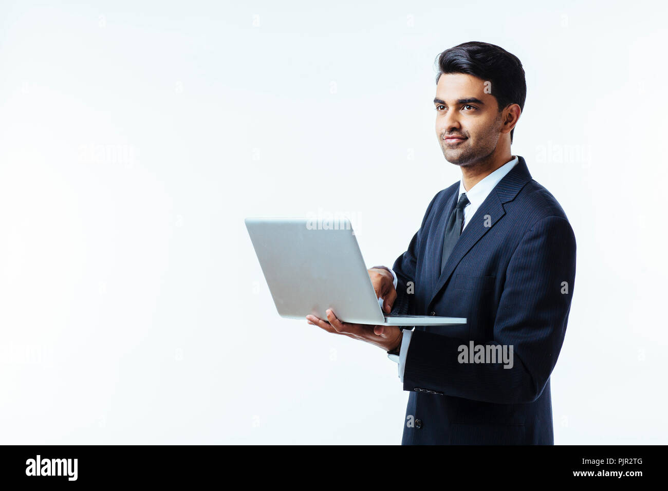 Portrait of a confident young man entrepreneur in business suit working ...