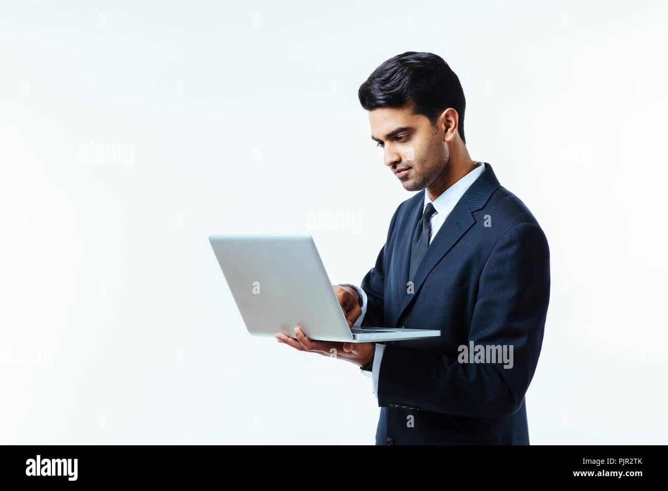 Portrait of a confident young man entrepreneur in business suit working ...