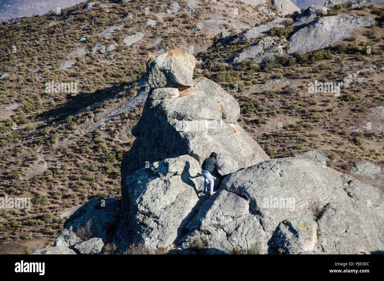 Traveling friends climbing the big rocks in Marcahuasi located east of ...