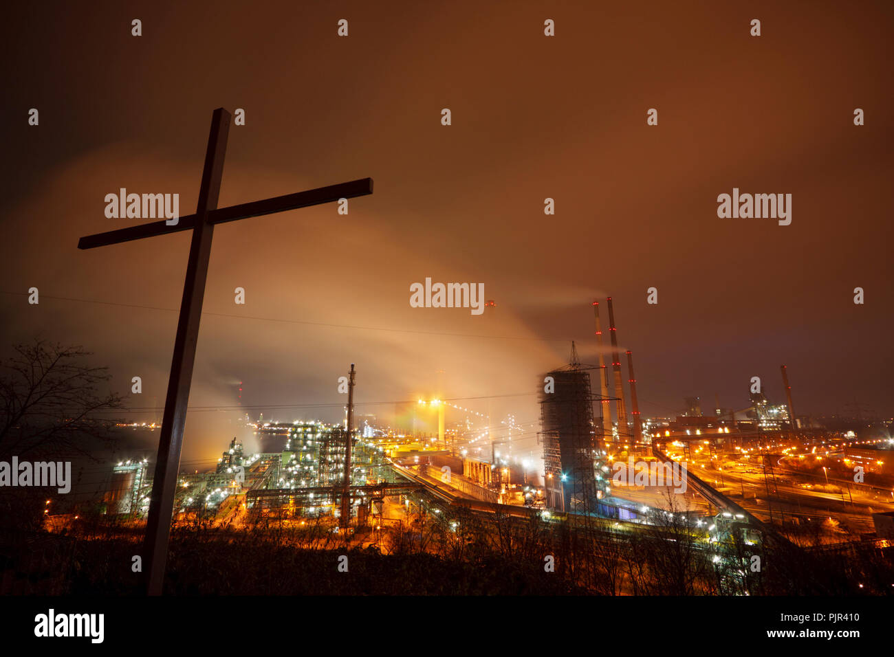 View into a large chemical plant from a slag heap with a memorial cross ...