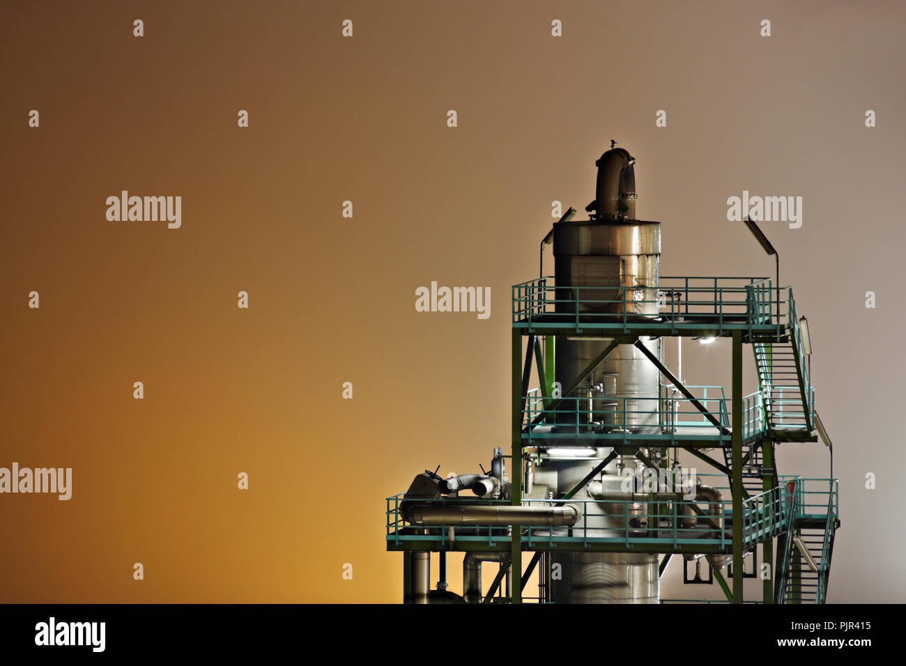 Night shot of a distillation tower isolated on steamy background Stock ...