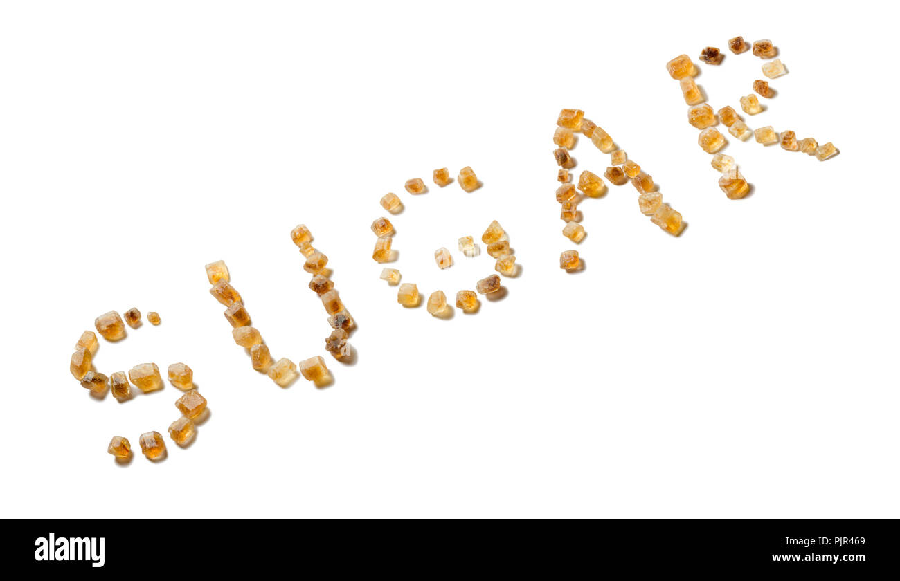The word SUGAR spelled with brown sugar crystals isolated on white ...