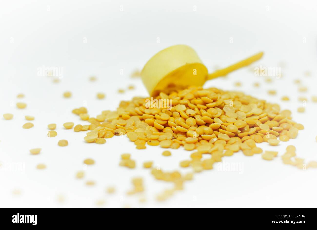 Legume - uncooked lentil or mung daal with spoon, in closeup view Stock ...