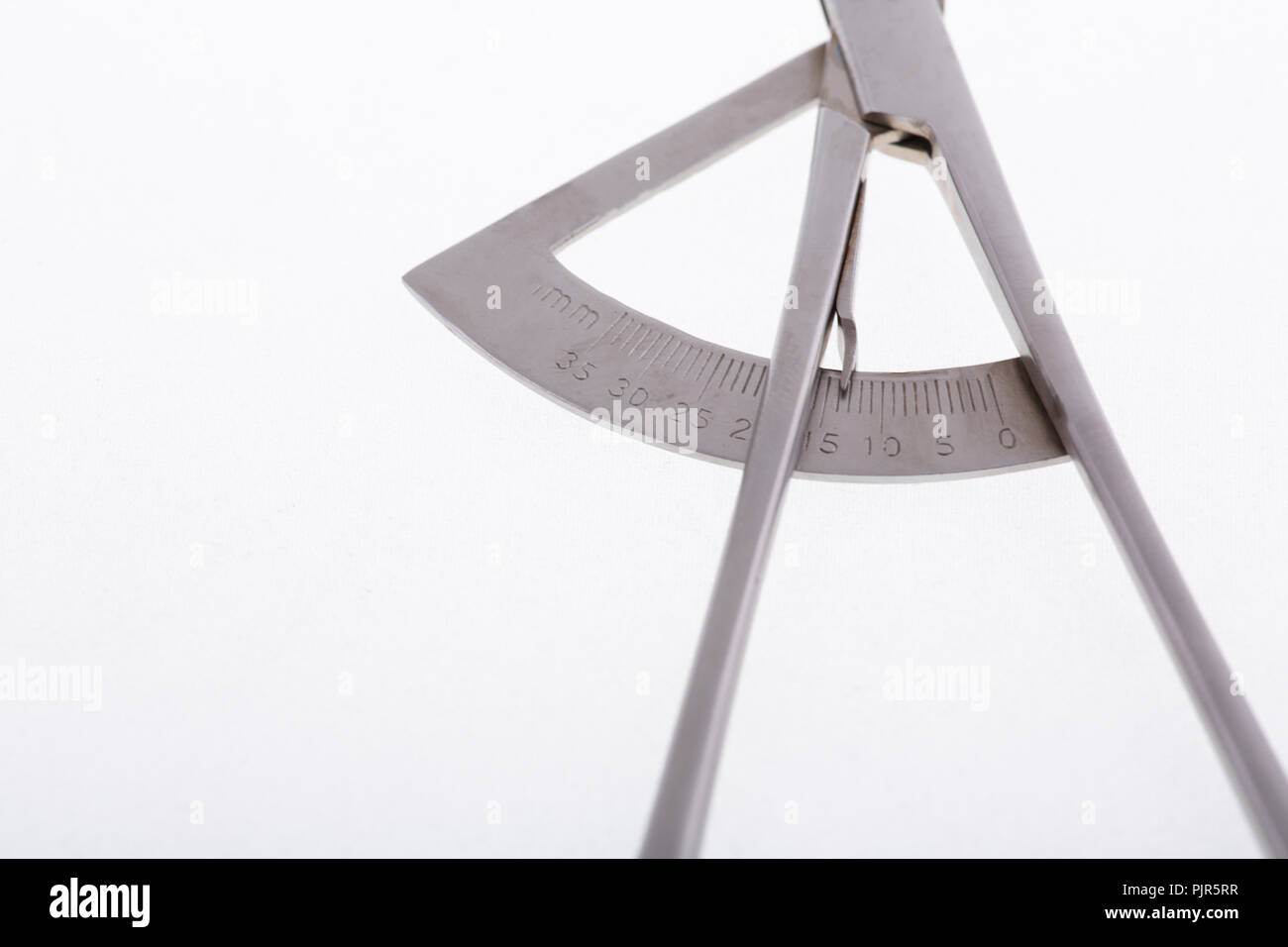 Dental caliper on white background. This instrument has calibrated ...