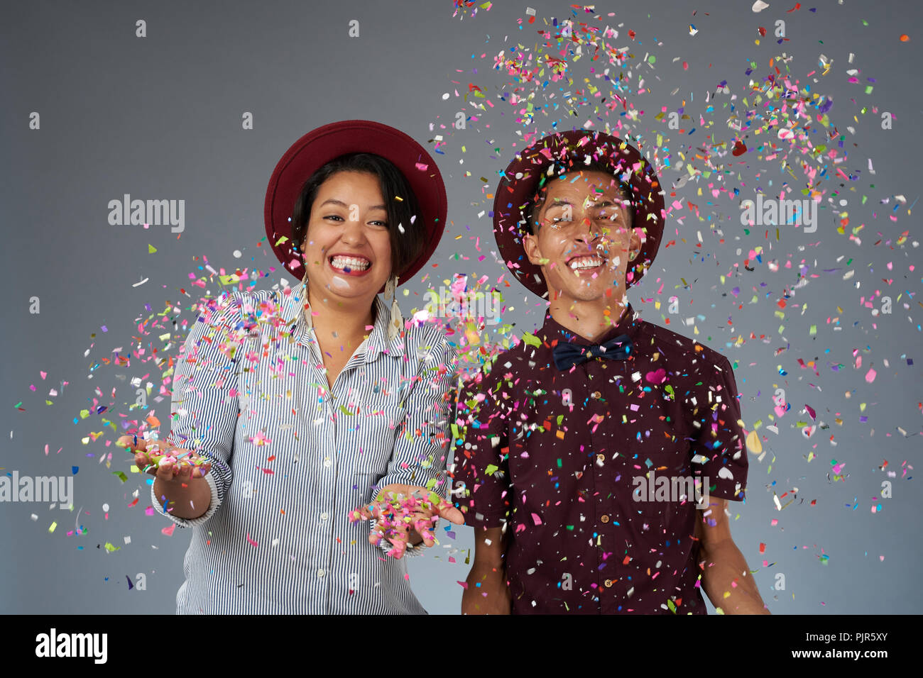 Party celebration theme. Young people throwing confetti on air Stock ...