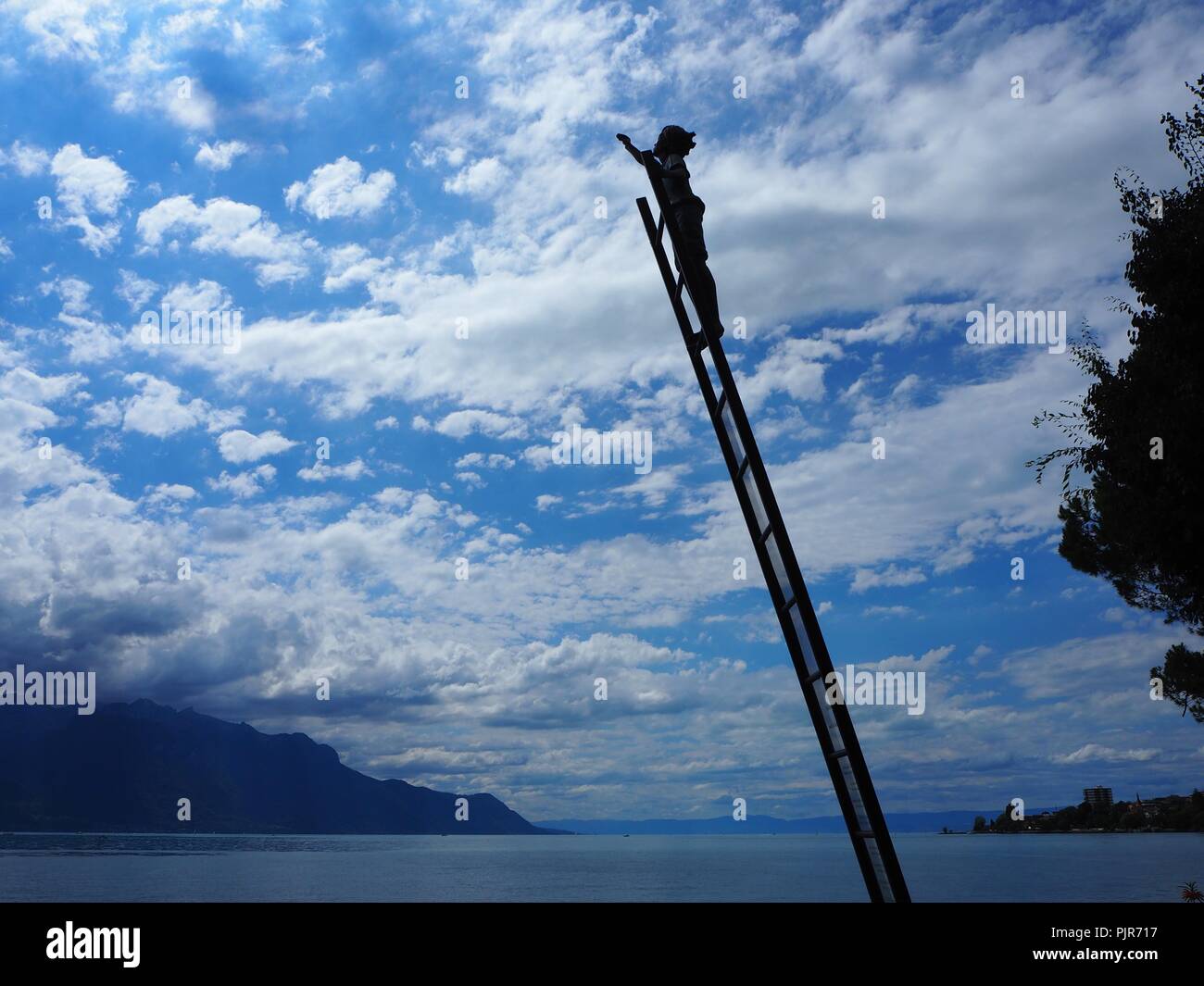Montreux, Switzerland - Lake side, statue showing boy climbing a ladder ...