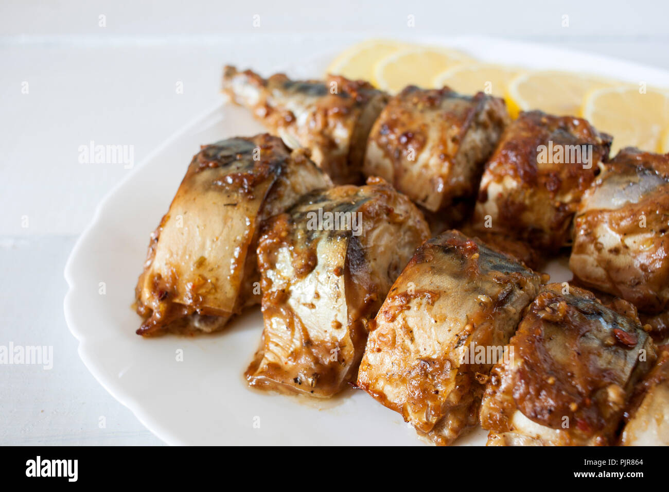 Marinated mackerel slices baked on the grill Stock Photo - Alamy