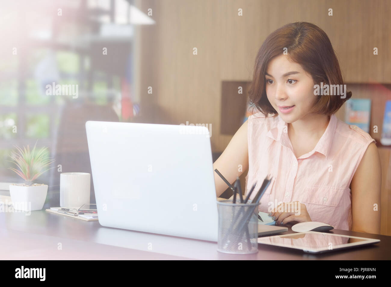 Asian working woman on workplace with laptop computer Stock Photo - Alamy