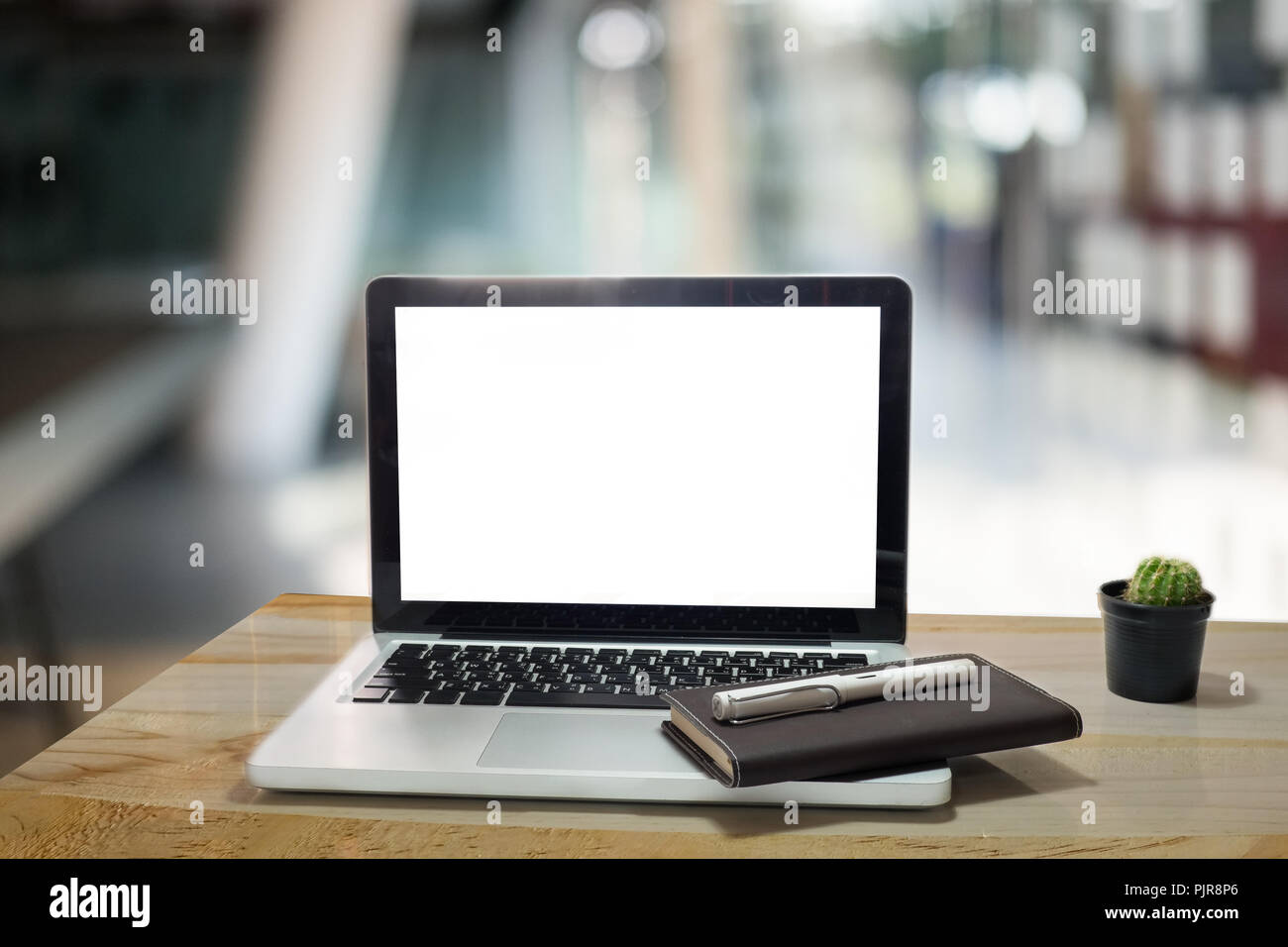 Laptop computer on workspace with mockup empty screen of laptop of ...