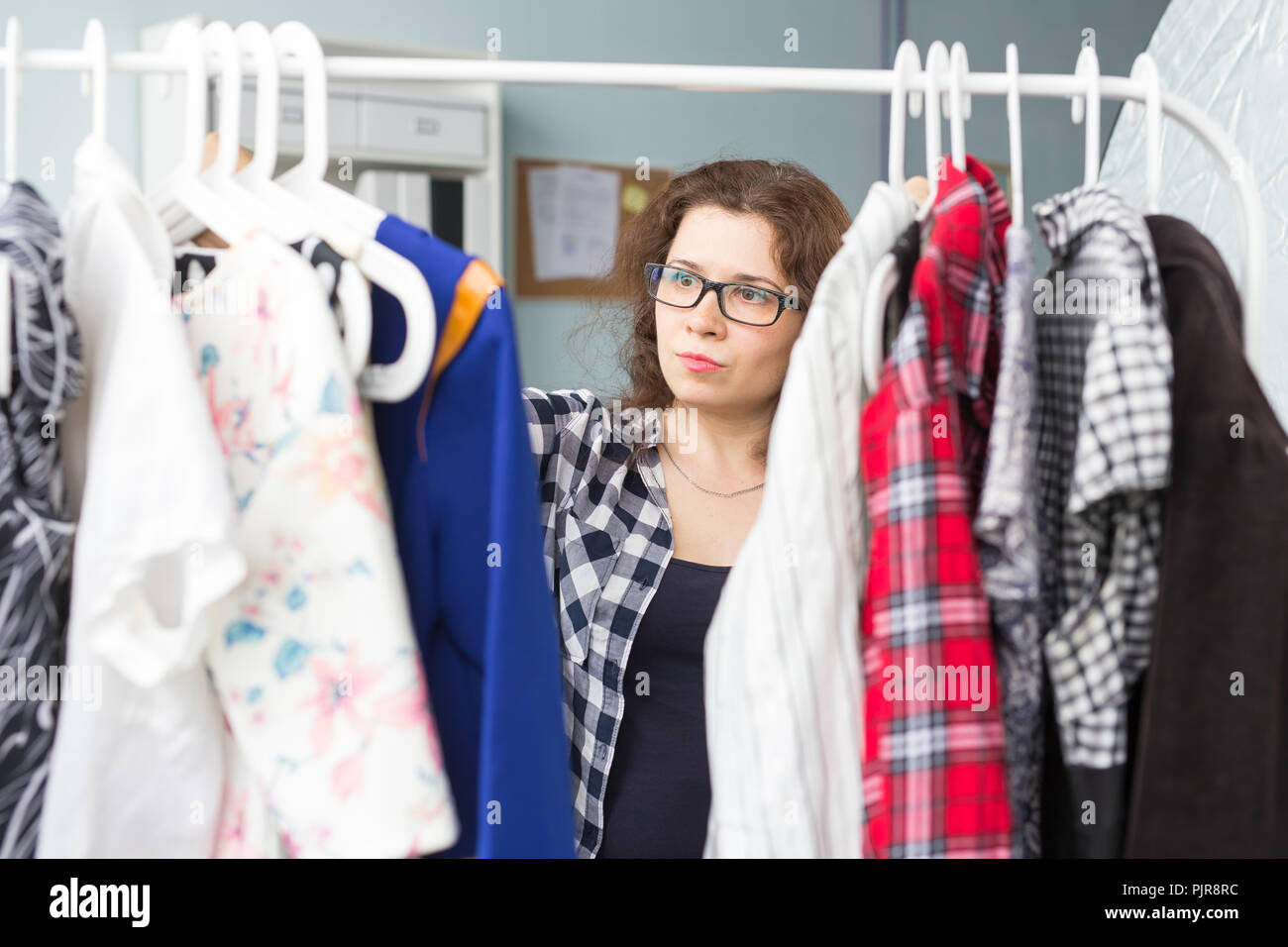 Beautiful brunette woman choosing clothes hi-res stock photography and ...