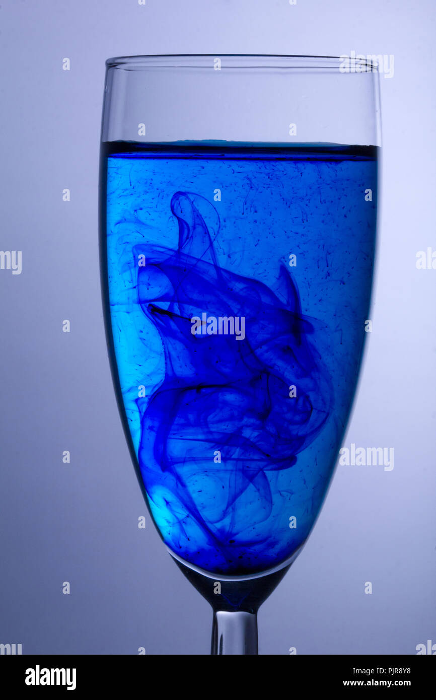 blue dye in glas filled with water Stock Photo - Alamy