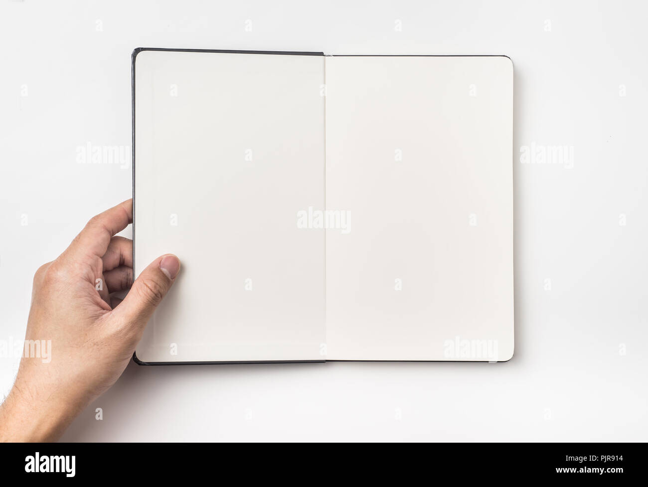 Business concept - Top view of man's hand hold black hardcover notebook ...